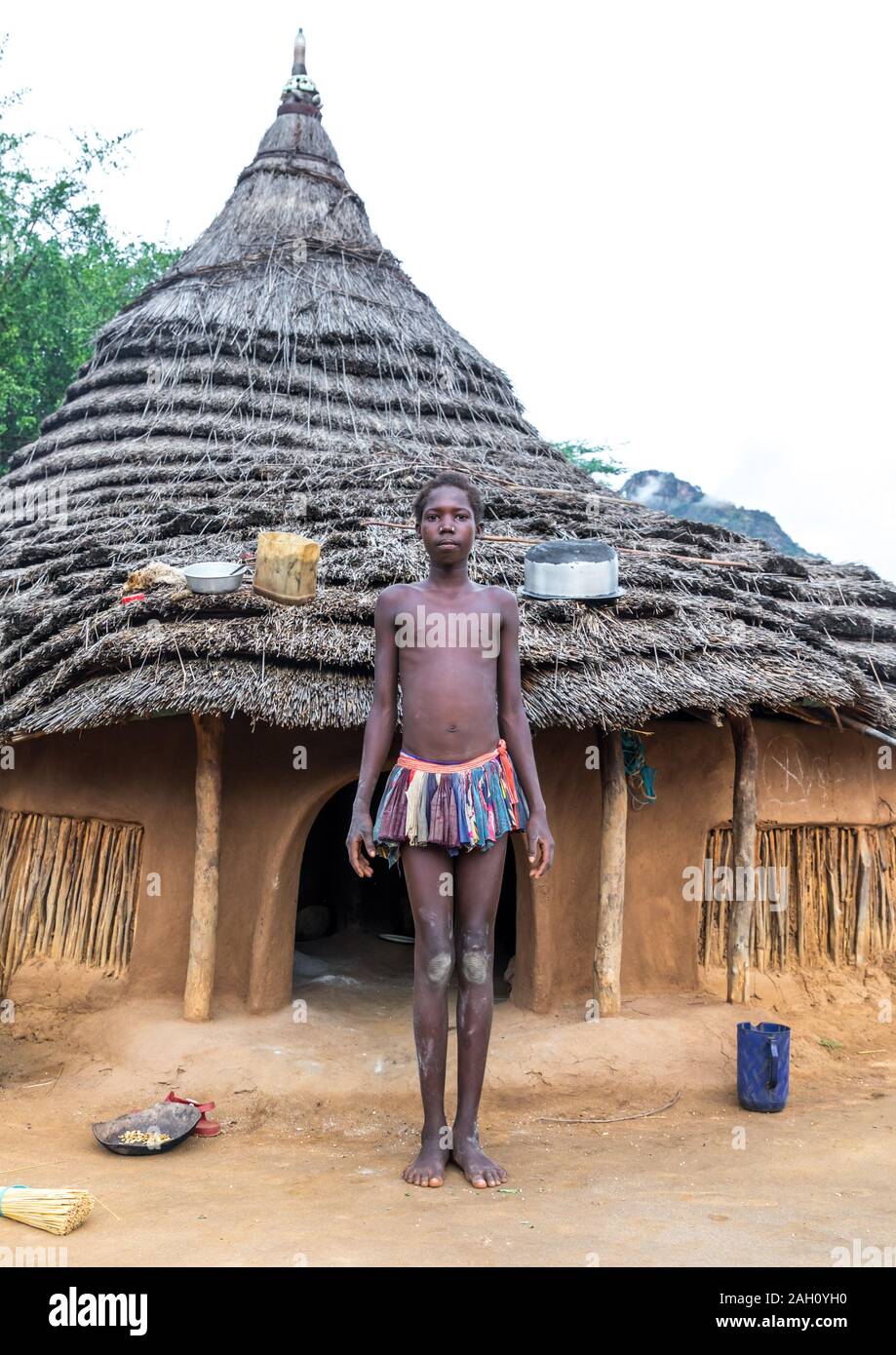Larim tribe teenage girl in front of her traditional house, Boya ...