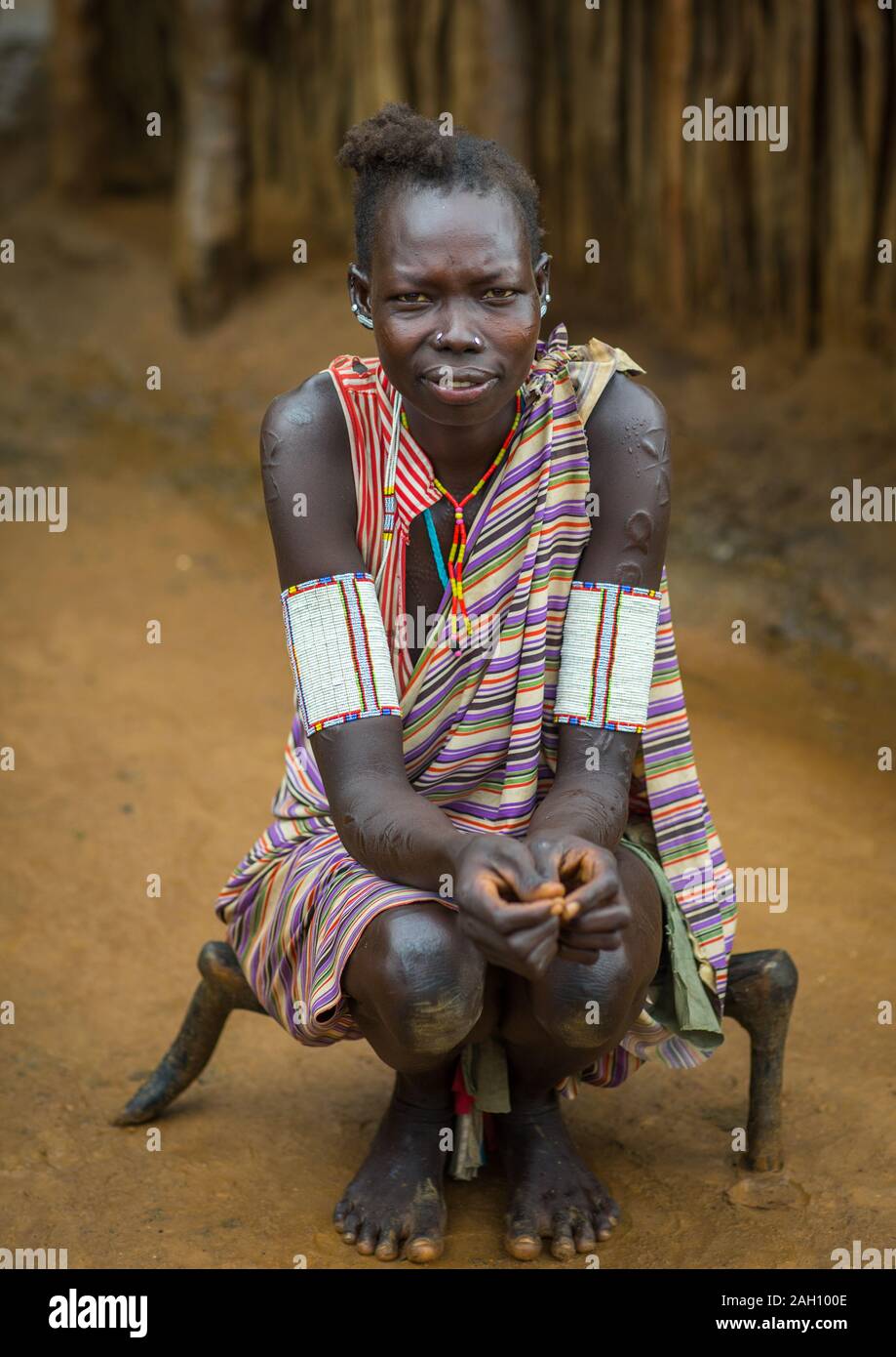 Portrait of a Larim tribe woman sit on a wooden seat, Boya Mountains ...
