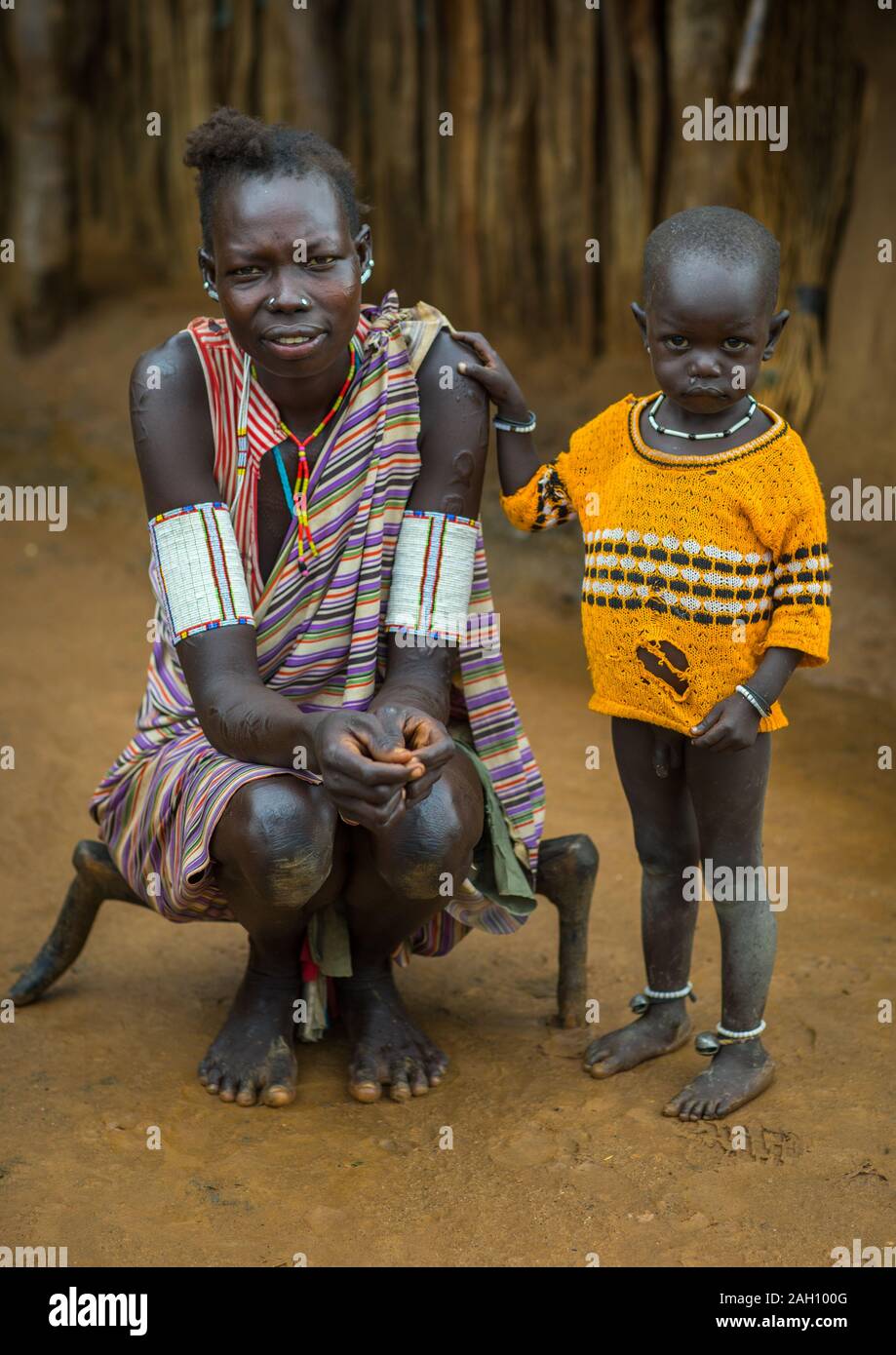 Larim tribe mother with arm necklaces with her son, Boya Mountains ...