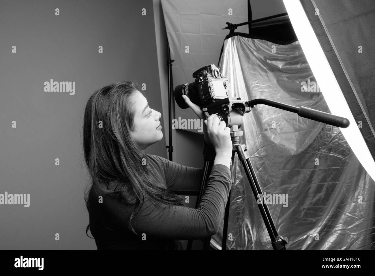 Young beautiful Indian woman vlogging against gray background Stock ...