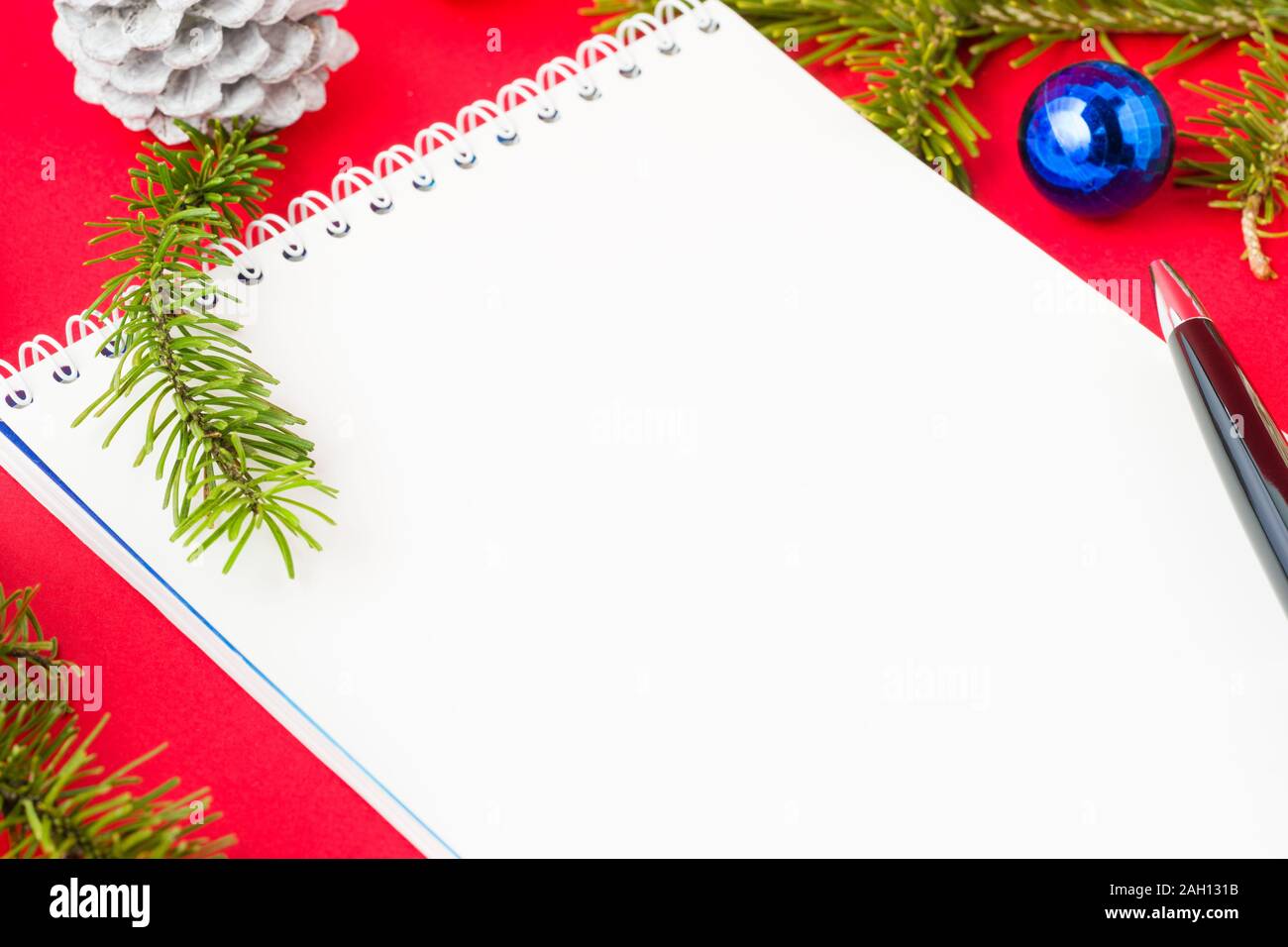 Christmas Notebook closeup on red background Stock Photo - Alamy