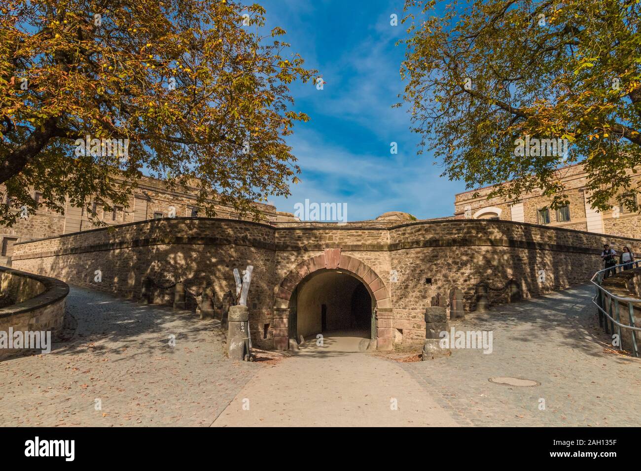 Flanked by two big tress, the tunnel inside the Ehrenbreitstein ...