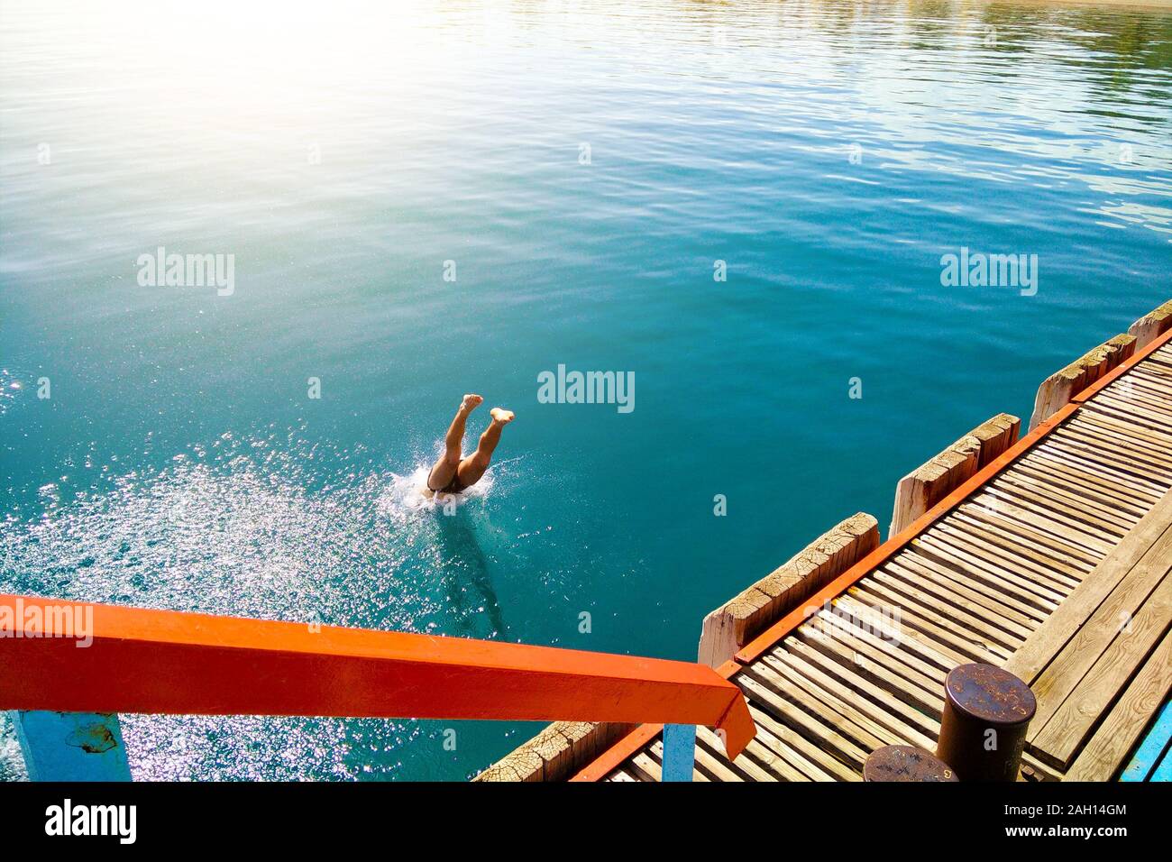 Man jumps from pier sea hi-res stock photography and images - Alamy