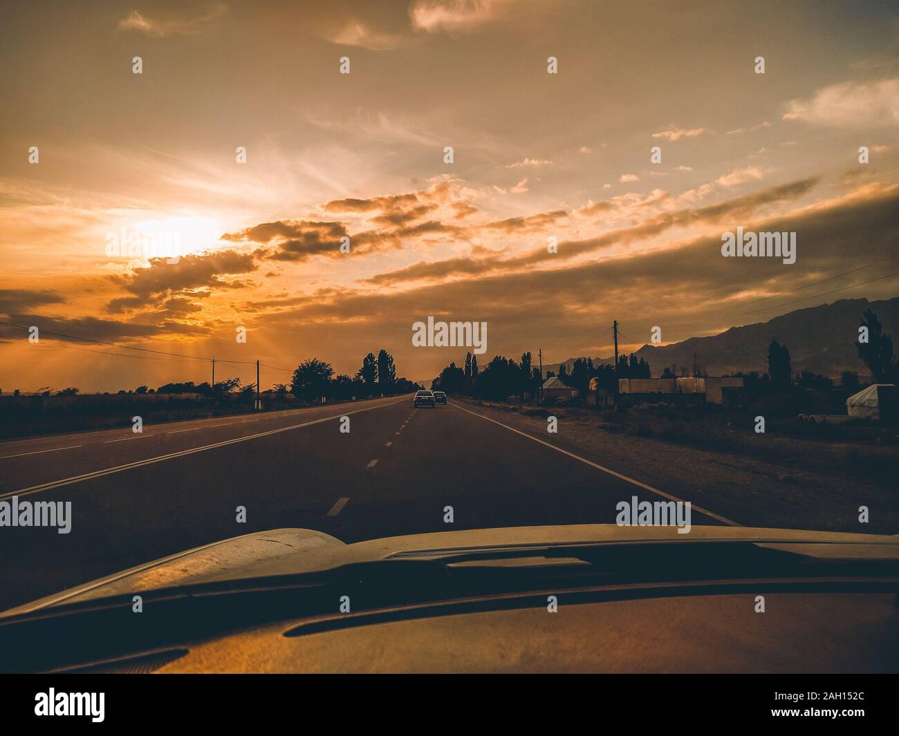Car driving on the highway. Road view from inside car behind console ...
