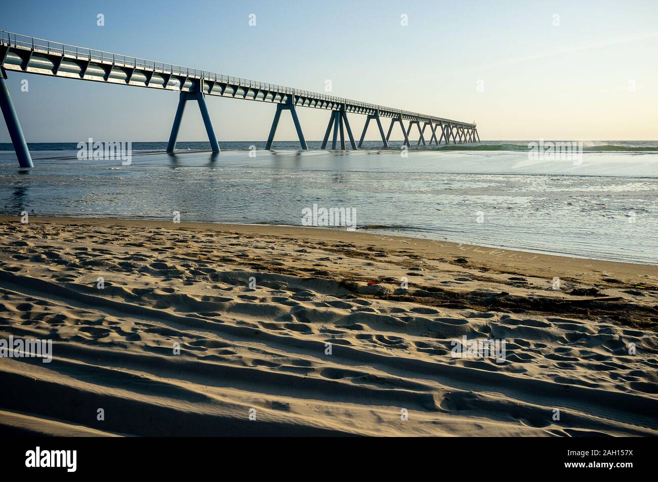 wharf for loading and unloading ships in the sunset Stock Photo - Alamy