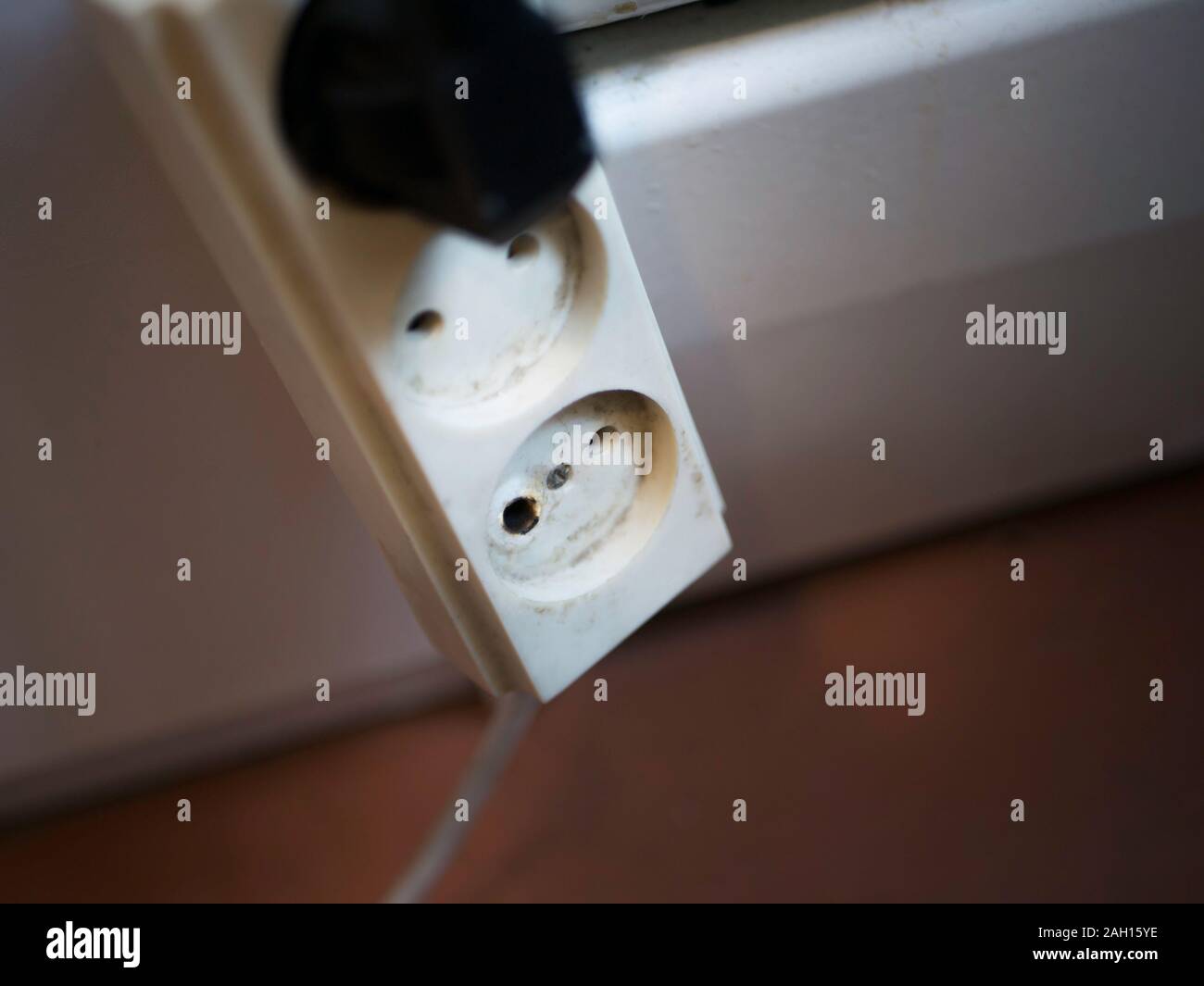 Burnt out old power socket Stock Photo - Alamy