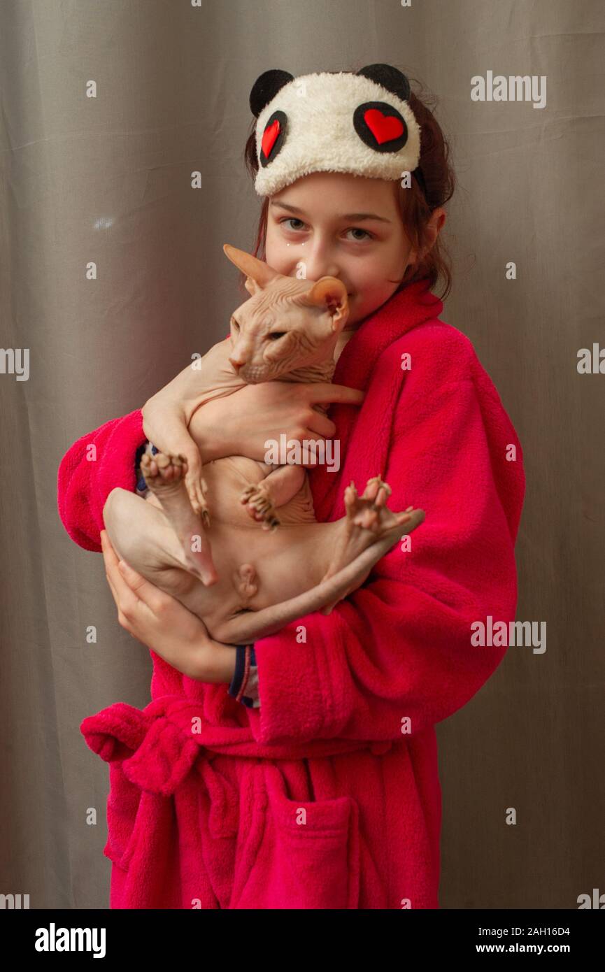 Picture of adorable young Caucasian female hugging her cute highbred ...