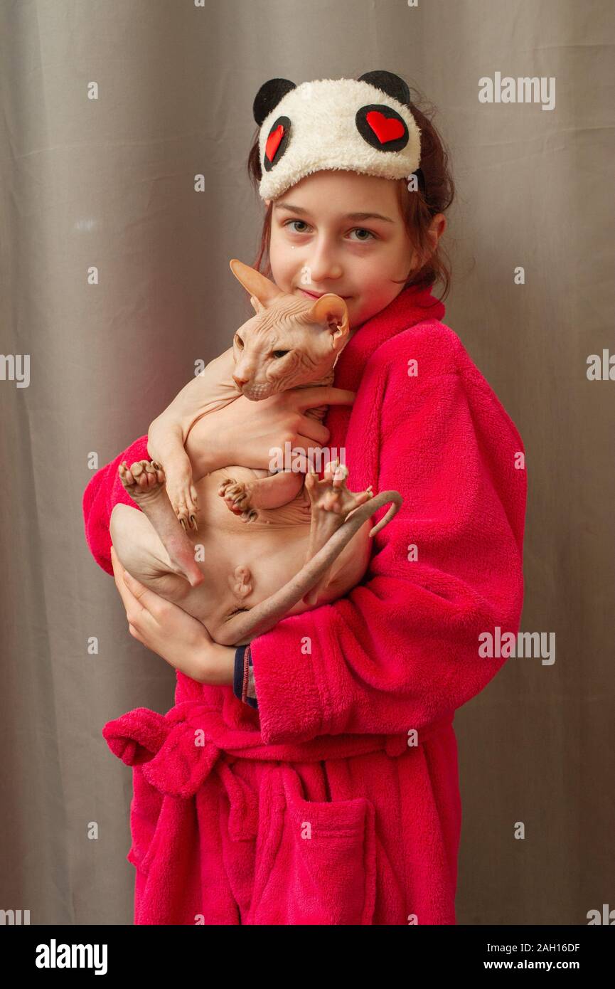 Picture of adorable young Caucasian female hugging her cute highbred ...