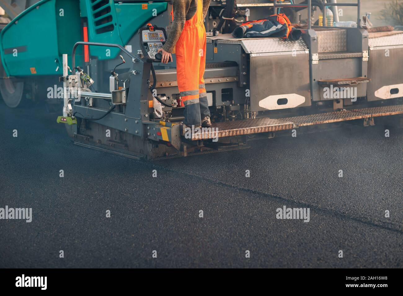 Asphalt paving. Paver machine. New road construction Stock Photo - Alamy