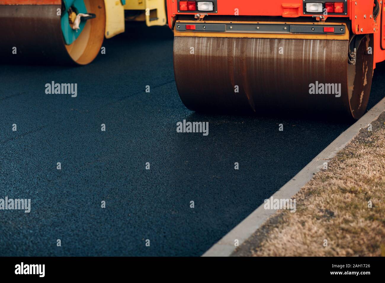 Asphalt paving. Paver road rollers. New road construction Stock Photo ...