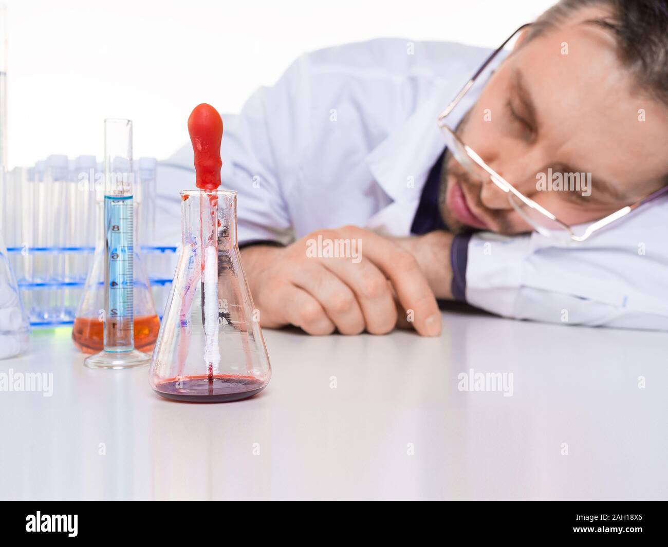 Exhausted scientist sleeping in laboratory. Science and experiment in ...