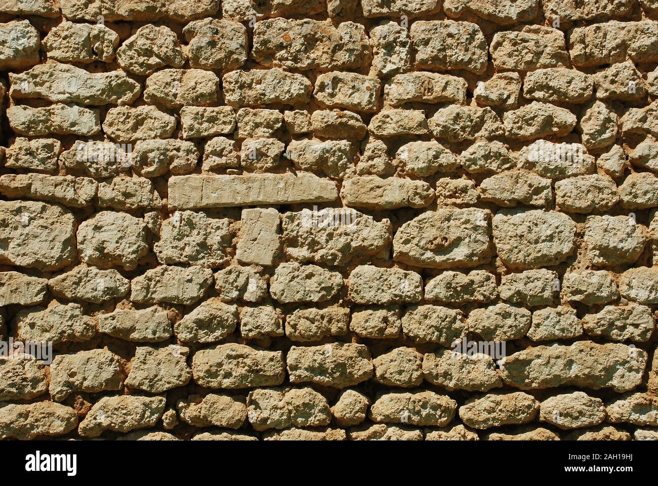 Solid wall made of stone Stock Photo - Alamy