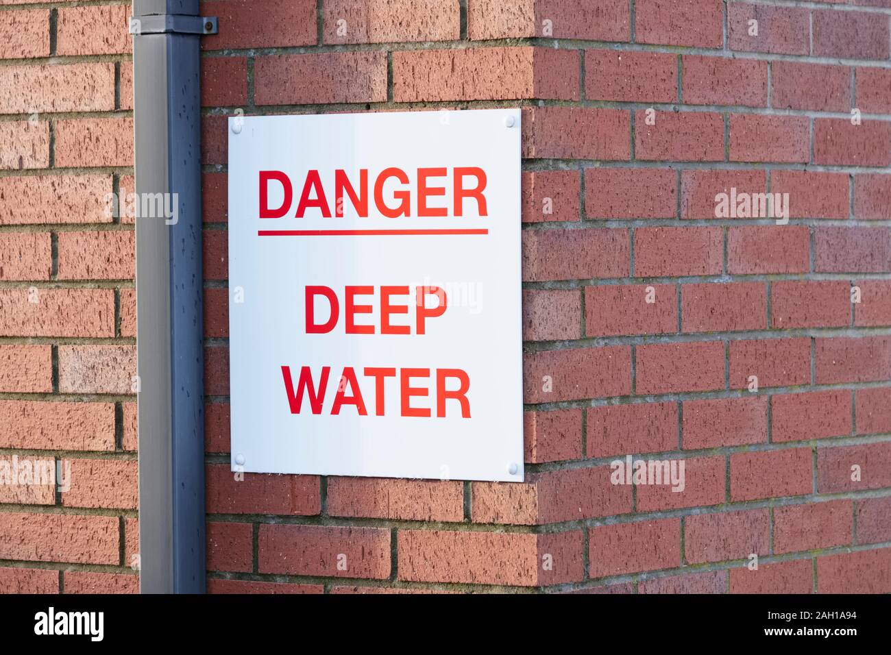 Deep water danger sign on sea wall Stock Photo - Alamy