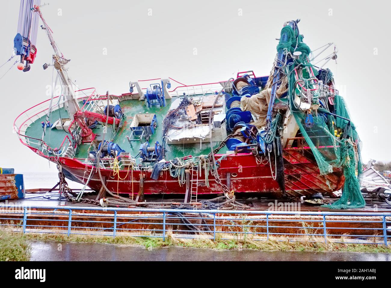 Capsized ship vessel and rescue lift crane at port dock for repair of ...