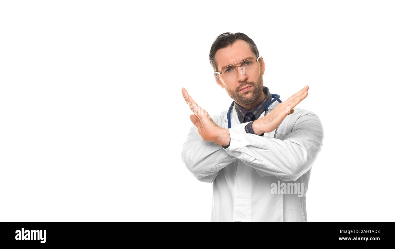 Male doctor showing stop sign. Doctor showing stop sign with his ...