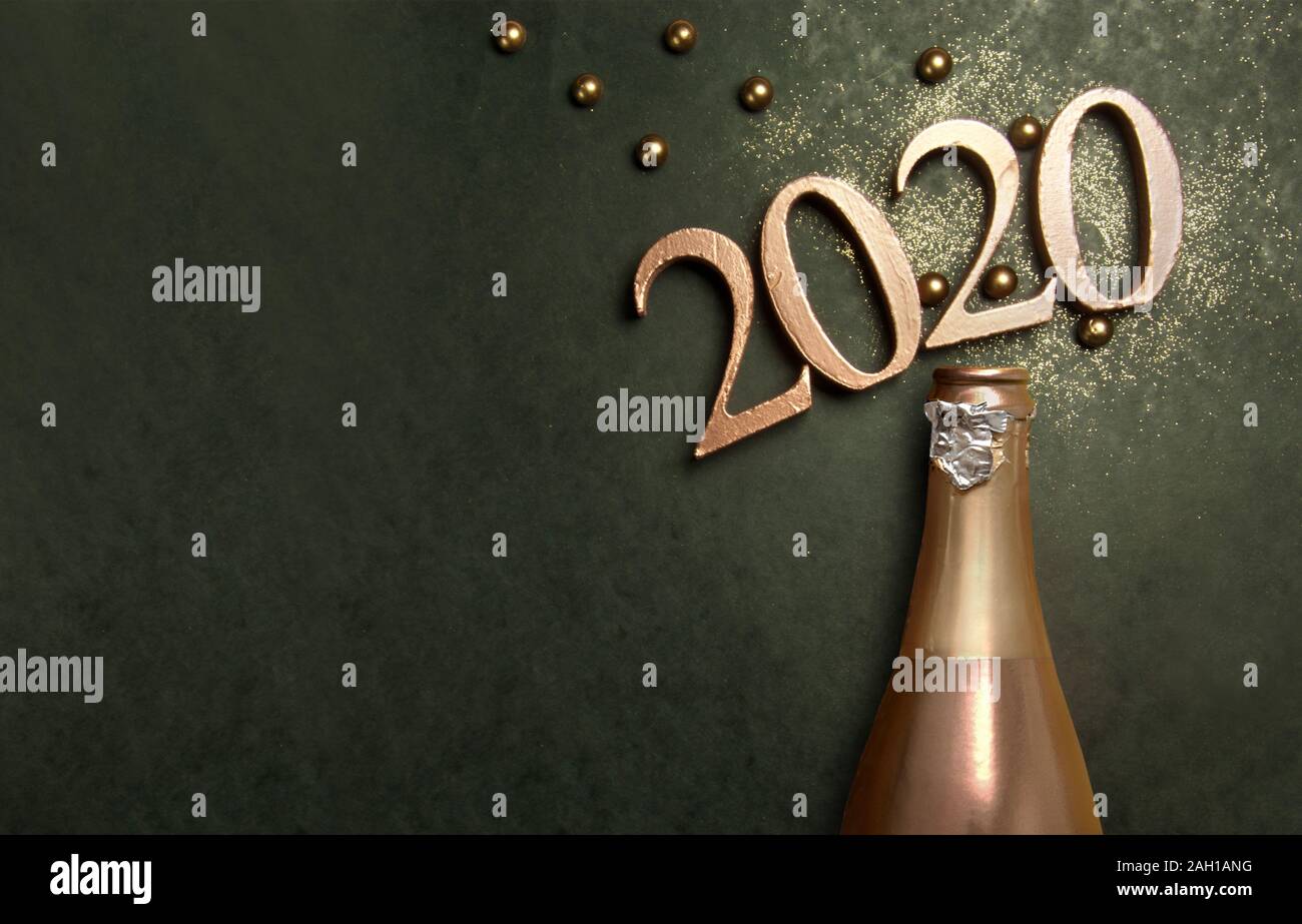 2020 champagne background, gold confetti and baubles coming out of a ...