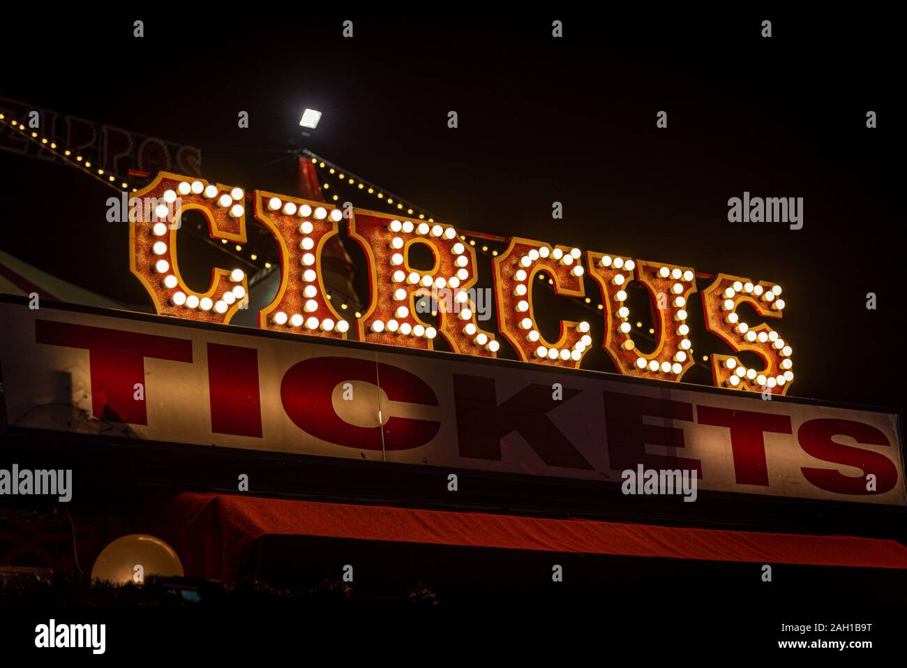 Old dimly lit circus sign with light bulbs in the dark over a ticket ...
