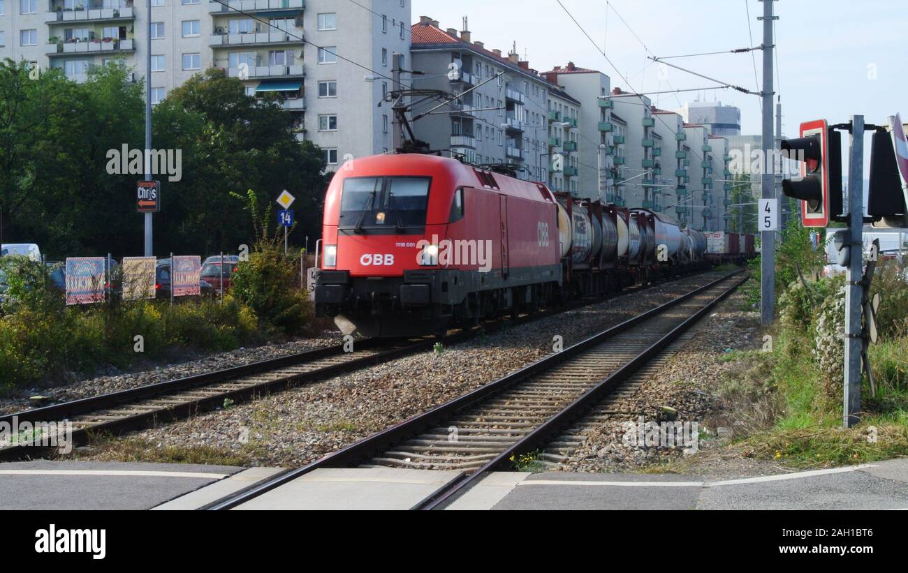 A OBB class 1116 Taurus electric powered locomotive with goods wagons ...