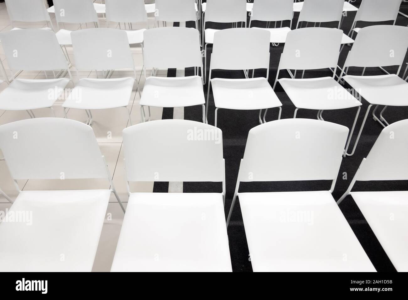 Rows of white plastic chairs for formal meetings, conference, lectures ...