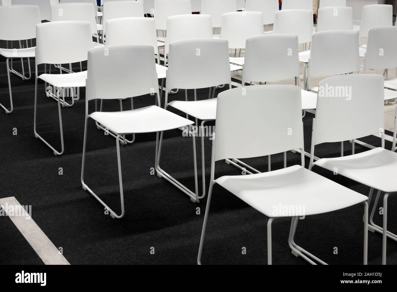 Rows of white plastic chairs for formal meetings, conference, lectures ...