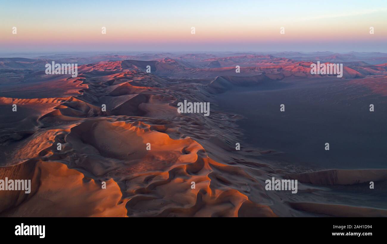 aerial view from the formation of tall sand dunes and deep valleys with ...