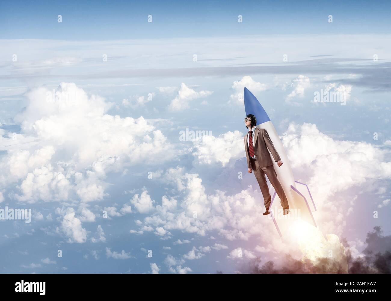 Businessman in suit and aviator hat flying on rocket in stratosphere ...