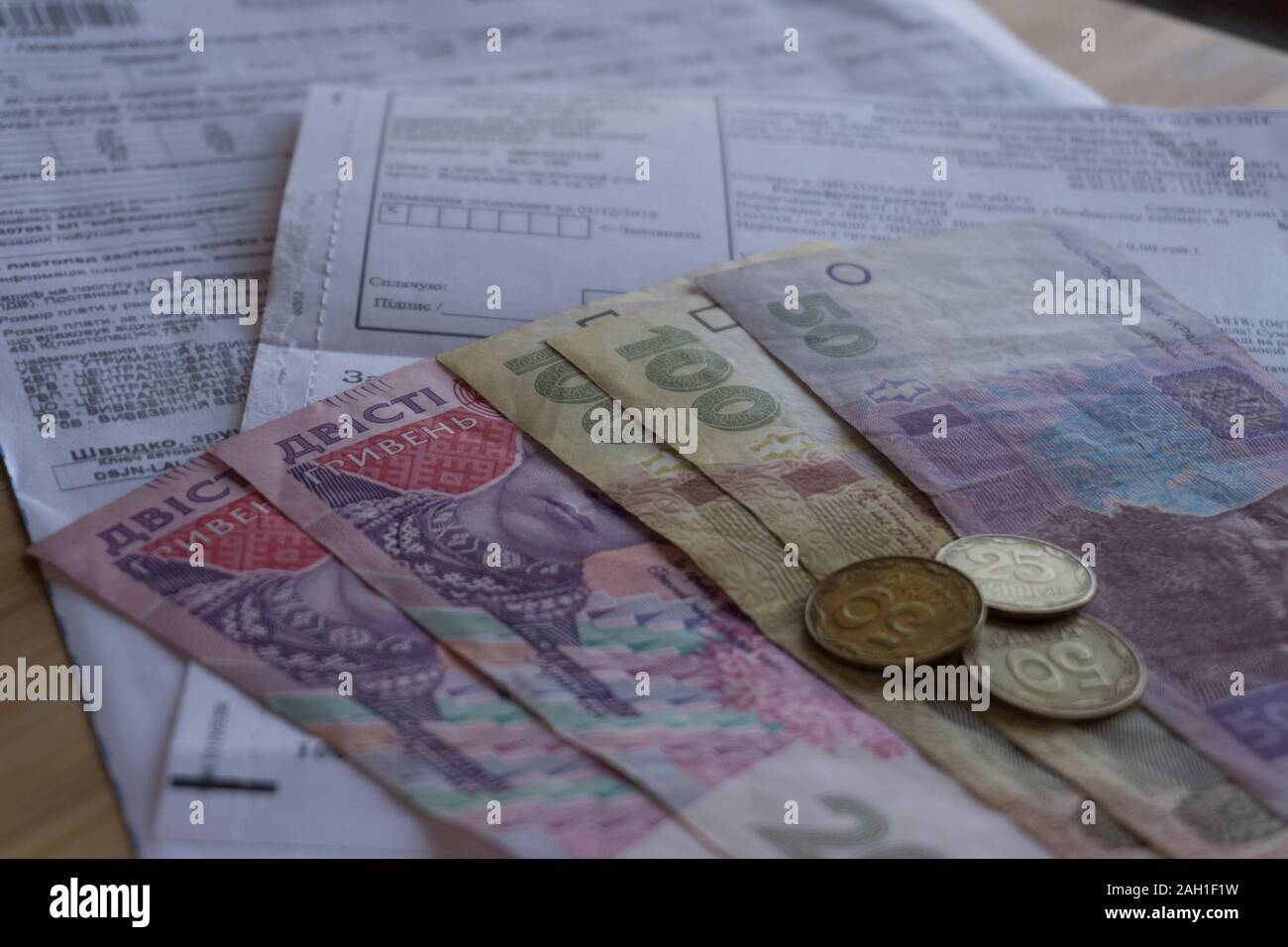 Ukrainian money hryvnia and coins penny wooden background, utility bill ...