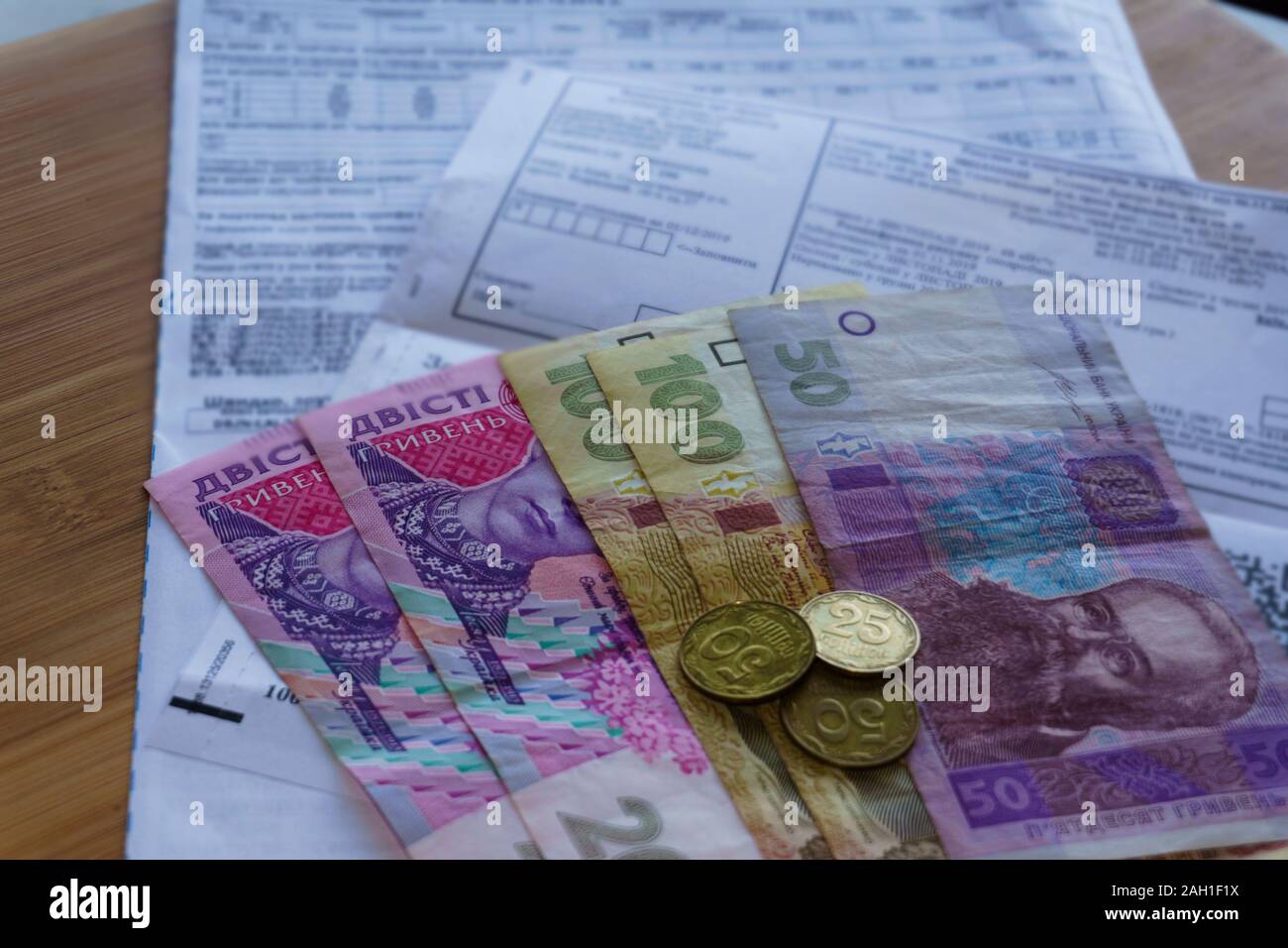 Ukrainian money hryvnia and coins penny wooden background, utility bill ...