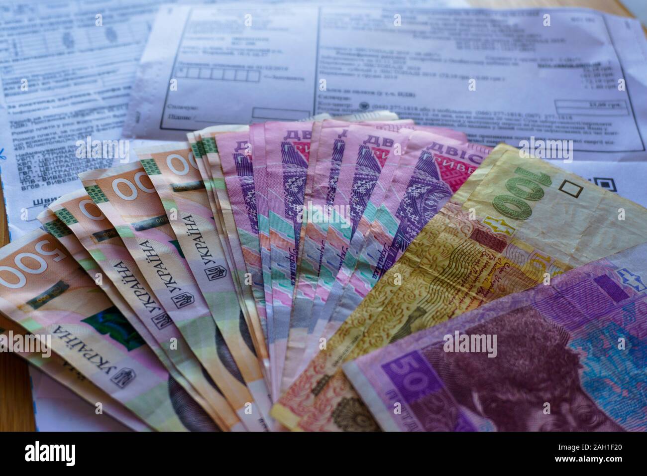 Ukrainian money hryvnia and coins penny wooden background, utility bill ...