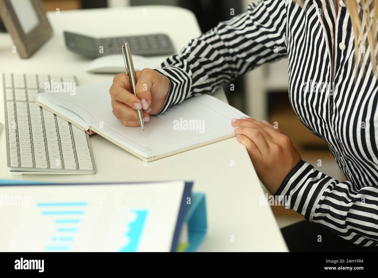 Company worker making notes Stock Photo - Alamy