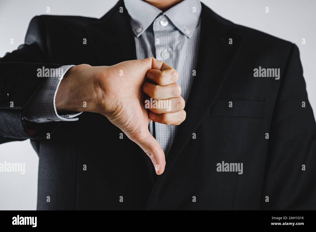 Business concept: thumbs down gesture. Symbol of difficulties in ...