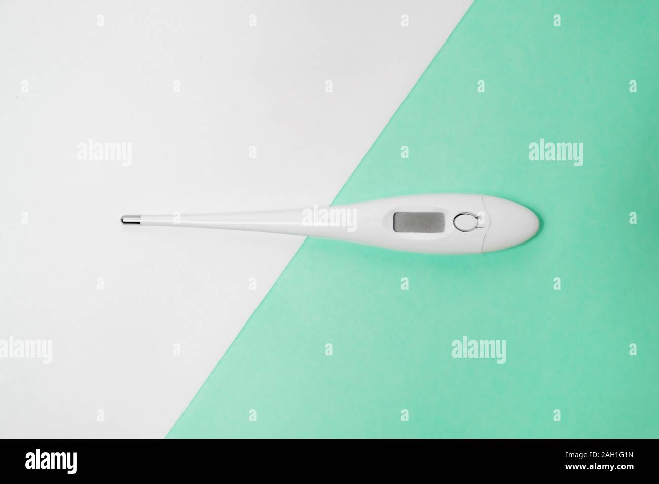 Electronic medical thermometer in two color background. Health issues ...