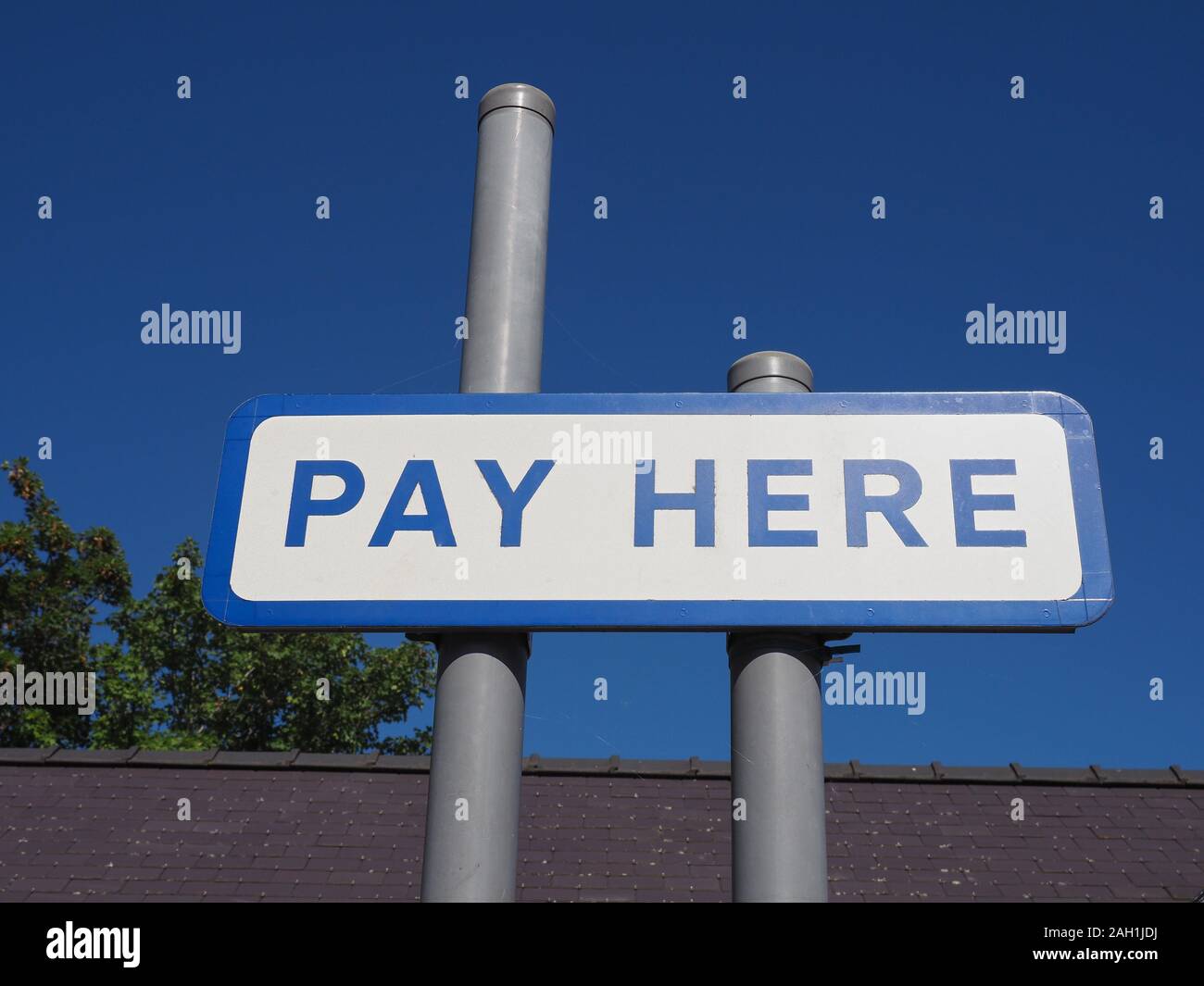 Pay Here sign in a parking lot Stock Photo - Alamy