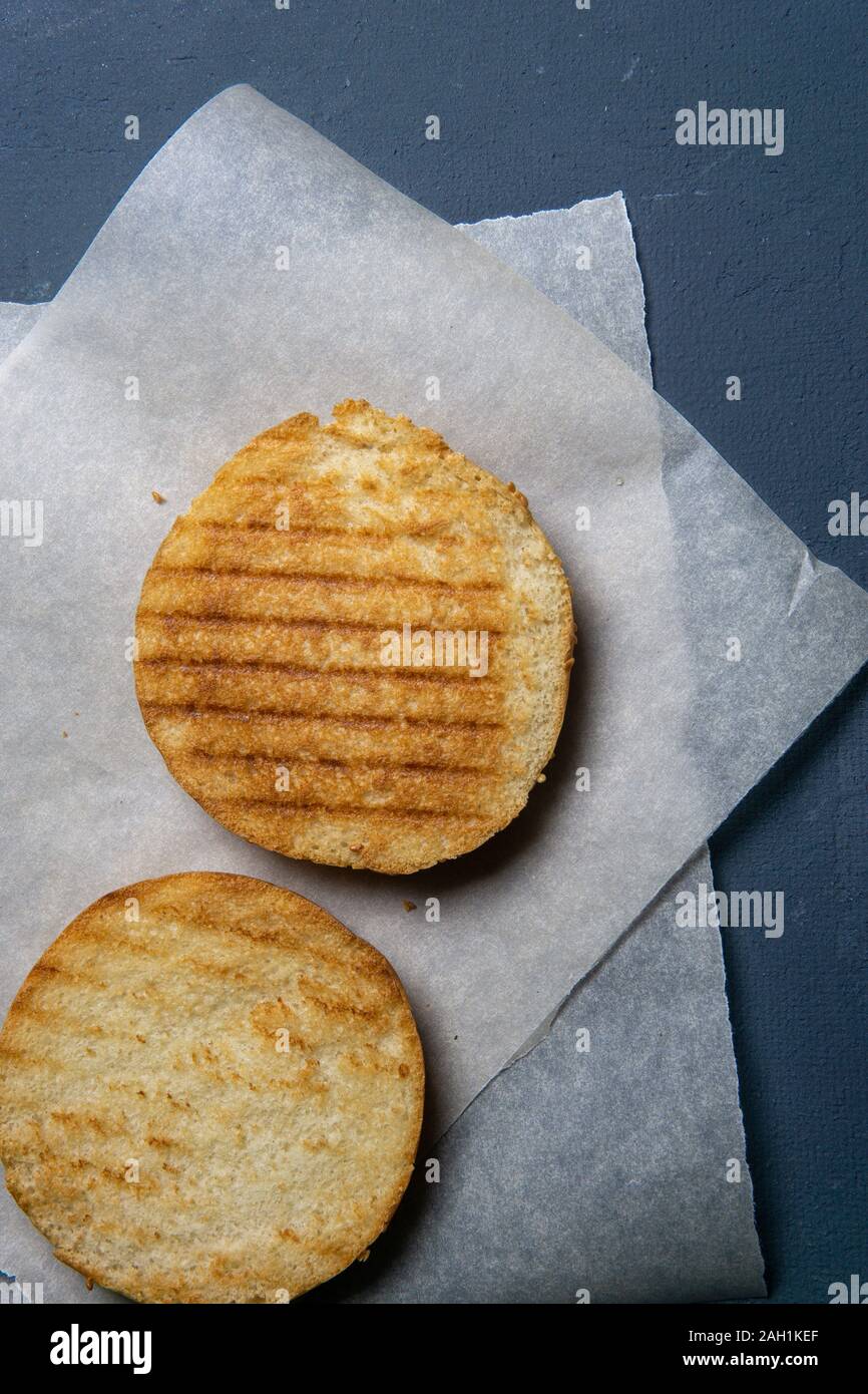grilled and cut in half burger bun on paper Stock Photo - Alamy