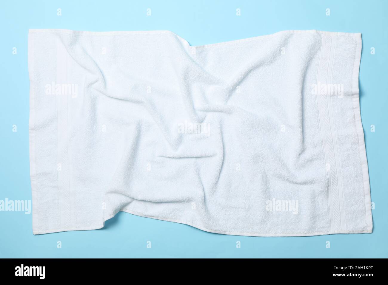 White crumpled towels on blue background, top view Stock Photo - Alamy
