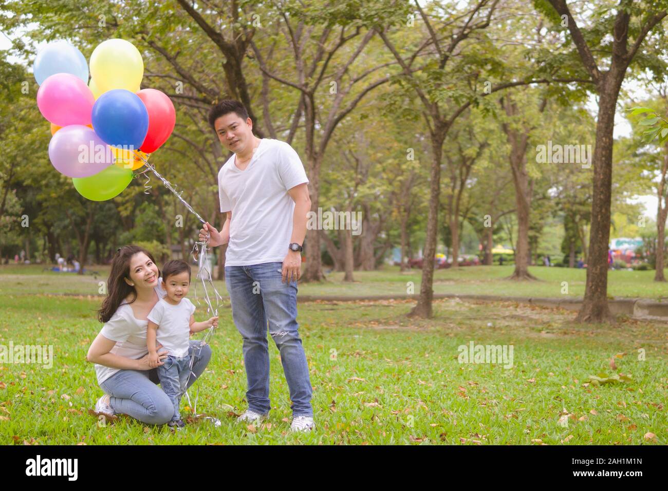 Happy father and mather playing with sun outside Stock Photo - Alamy