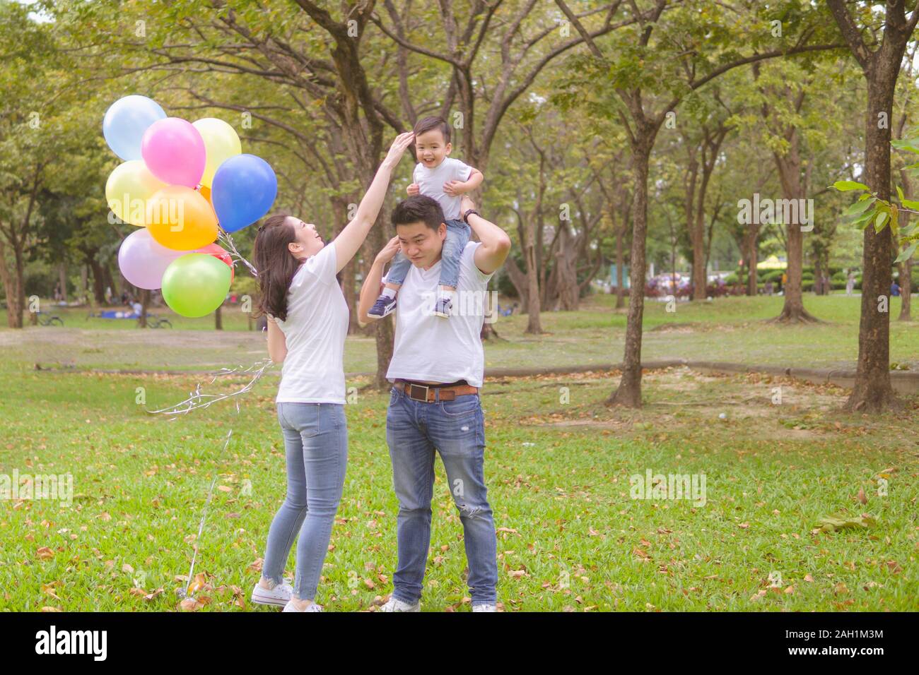 Happy father and mather playing with sun outside Stock Photo - Alamy