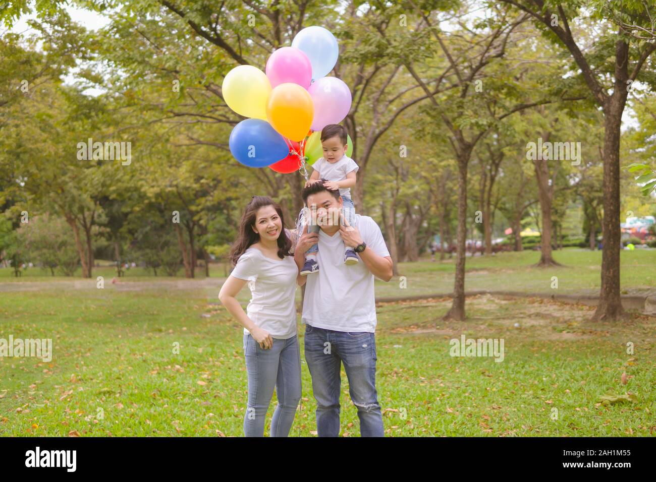 Happy father and mather playing with sun outside Stock Photo - Alamy