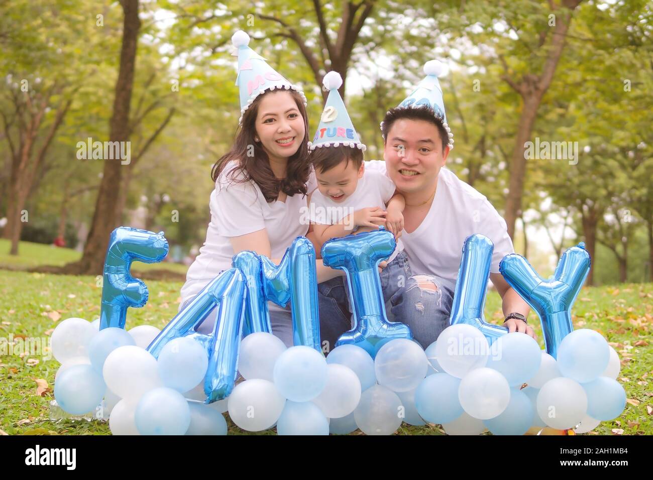 Happy father and mather playing with sun outside Stock Photo - Alamy