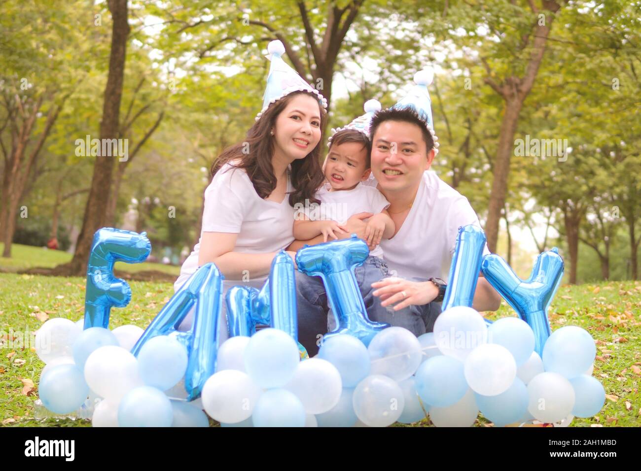 Happy father and mather playing with sun outside Stock Photo - Alamy