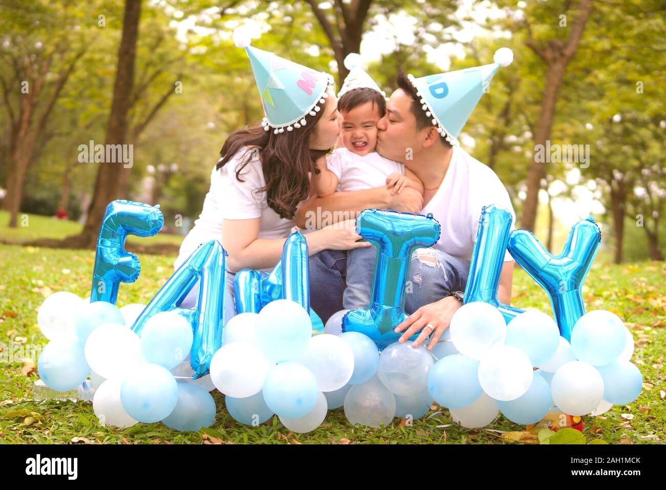 Happy father and mather playing with sun outside Stock Photo - Alamy