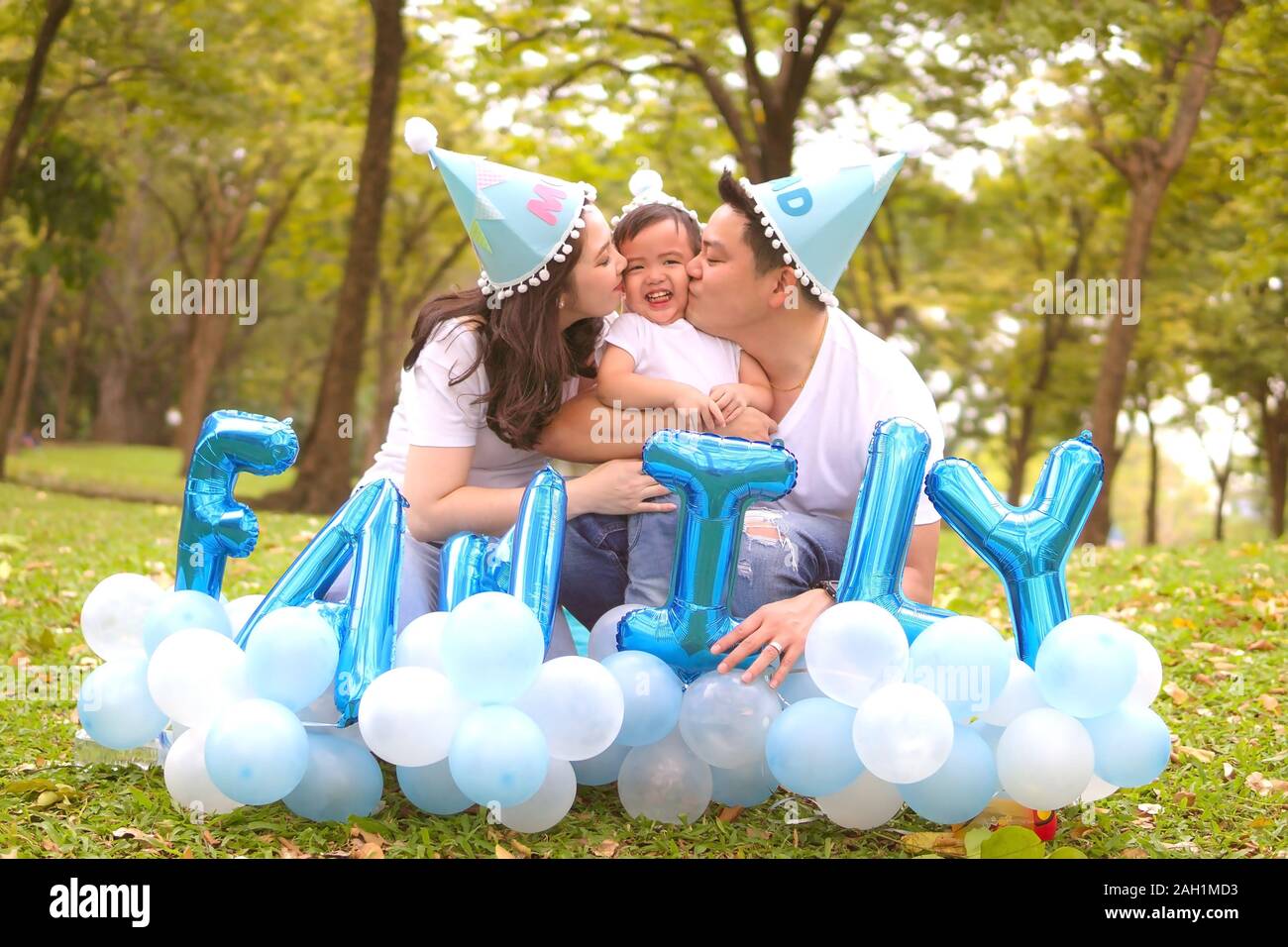 Happy father and mather playing with sun outside Stock Photo - Alamy