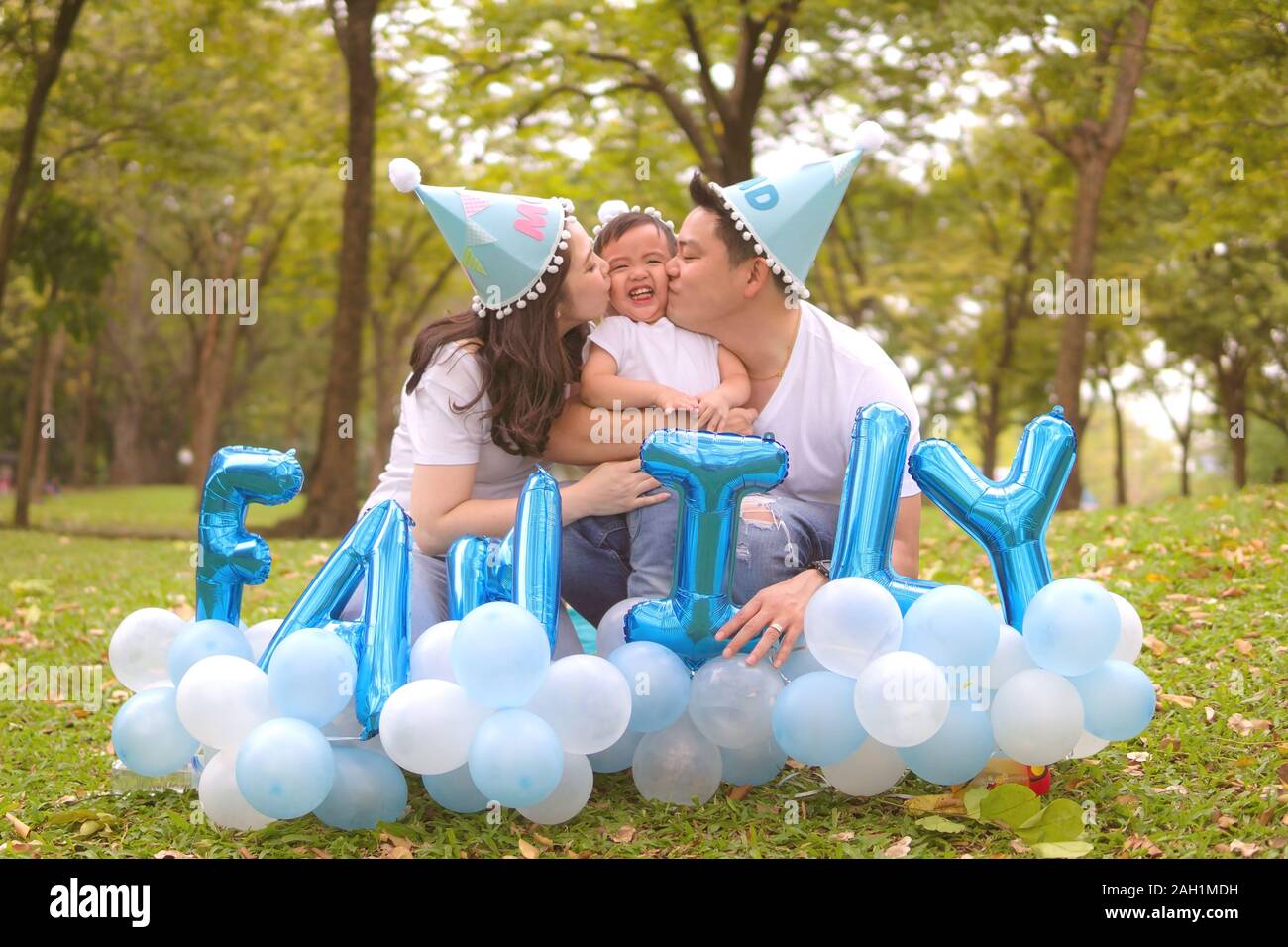 Happy father and mather playing with sun outside Stock Photo - Alamy