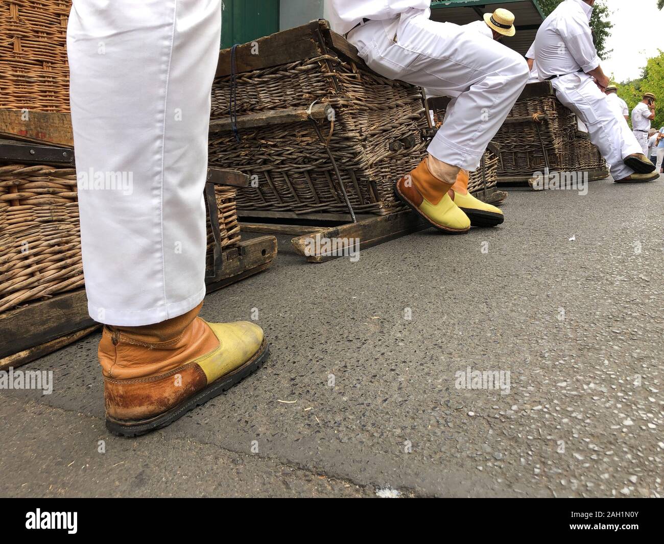 The toboggan drivers or Carreiros with their basket cars waiting for ...