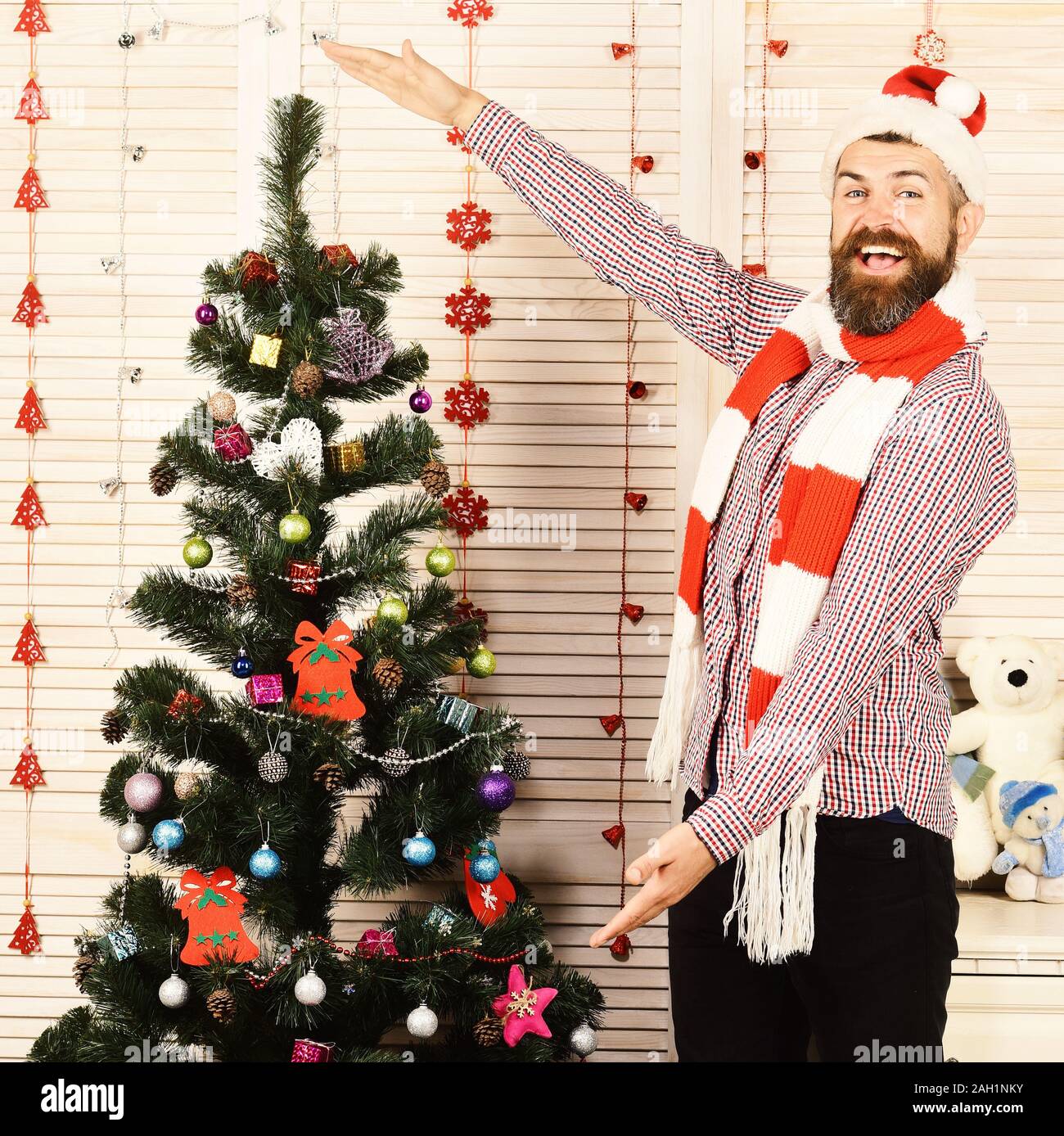 Santa Claus with smiling face on wooden wall background. Guy decorates ...