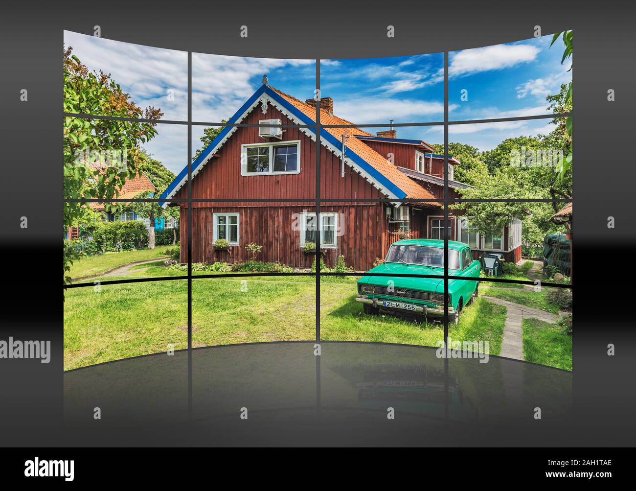 Typical House in Nida. In the garden stands an old car of the brand ...