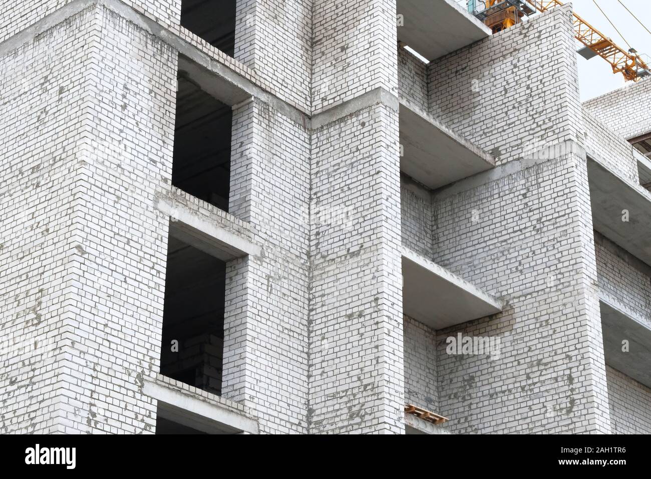 Facade of many story house under construction. House under construction ...