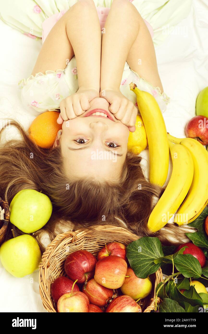 small happy girl eating exotic fruit or summer background Stock Photo ...