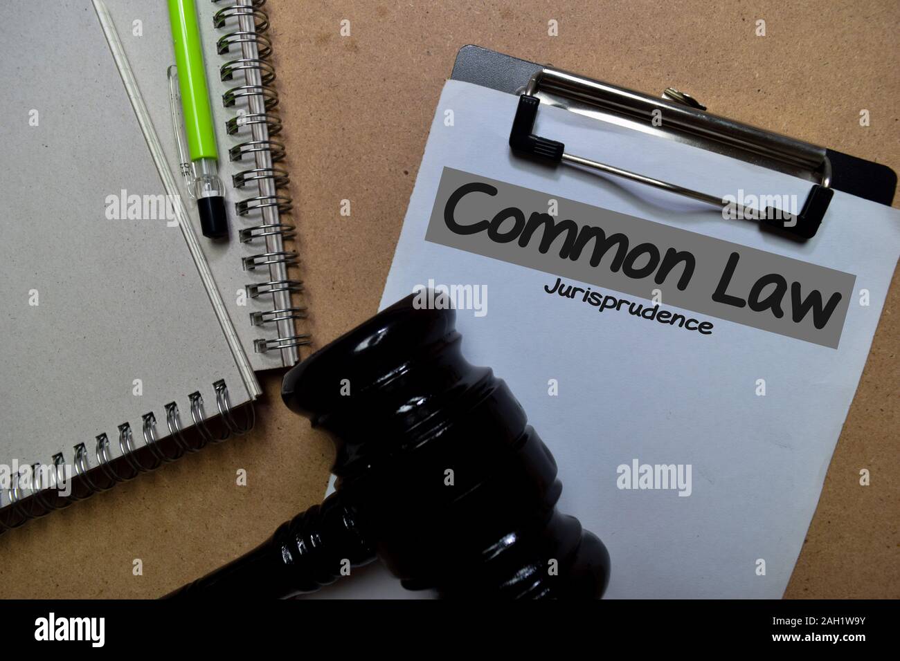 Common Law and Jurisprudence write on a paperwork with gavel isolated ...