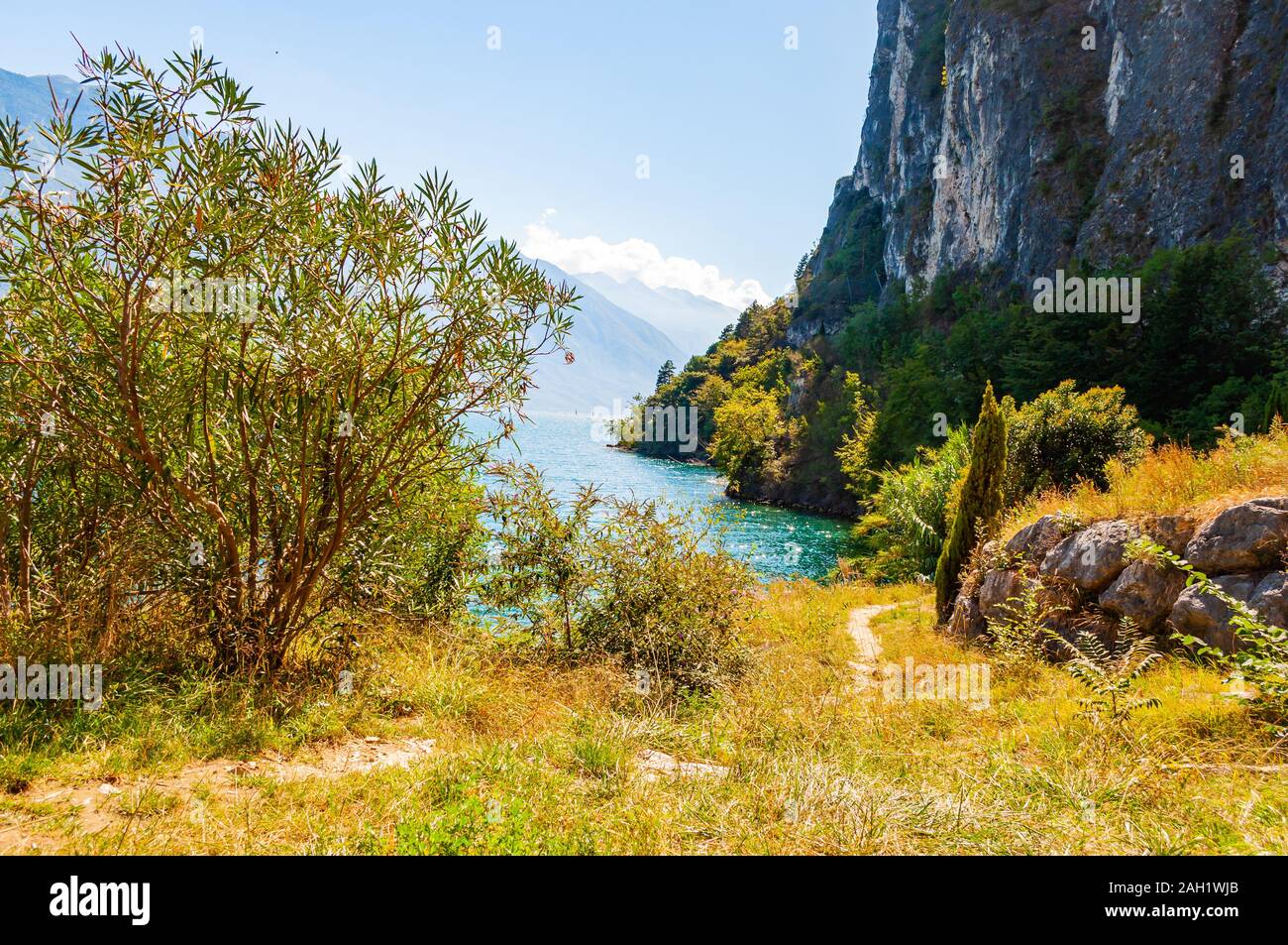 Scenic pathway leading to Garda lake shore under the dolomite mountain ...